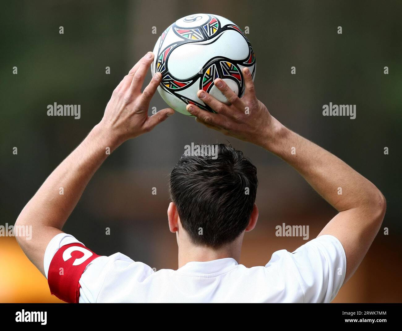 Footballer taking a throw-in Stock Photo - Alamy