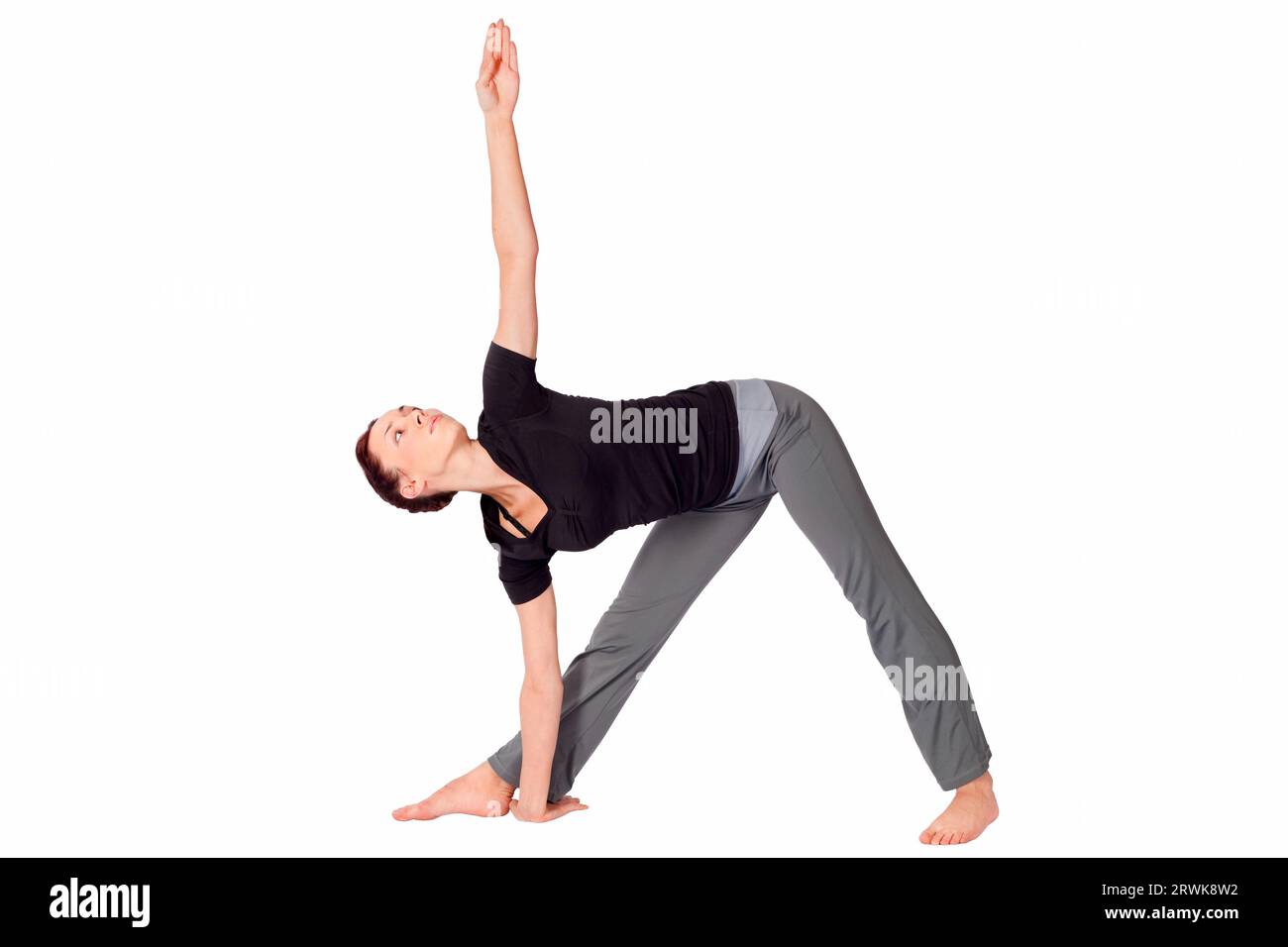 Young fit woman doing yoga exercise called Triangle Pose (Sanskrit name ...