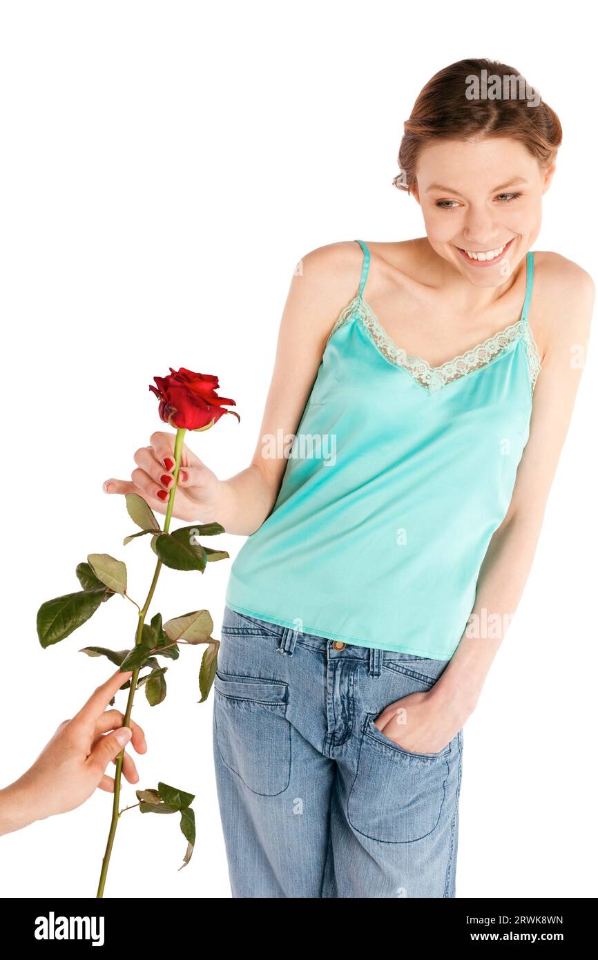 Young beautiful happy cheerful woman taking a single rose from a man ...