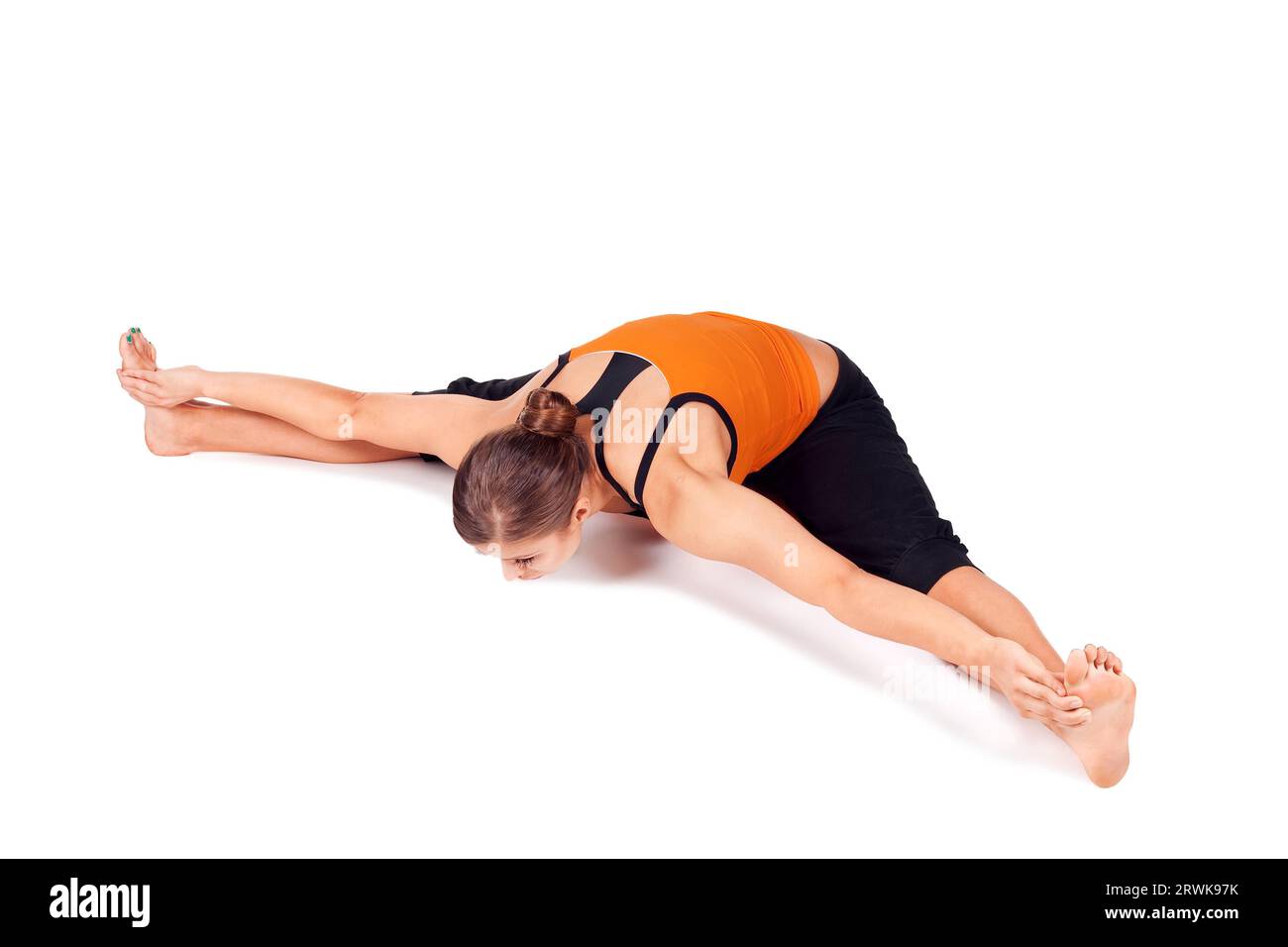 Woman doing yoga exercise called Seated Wide Angle Pose, sanskrit name ...