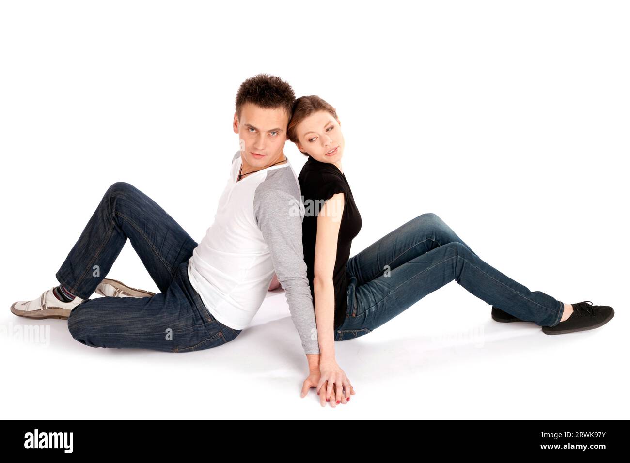 Young attractive loving couple sitting back to back on white isolated ...