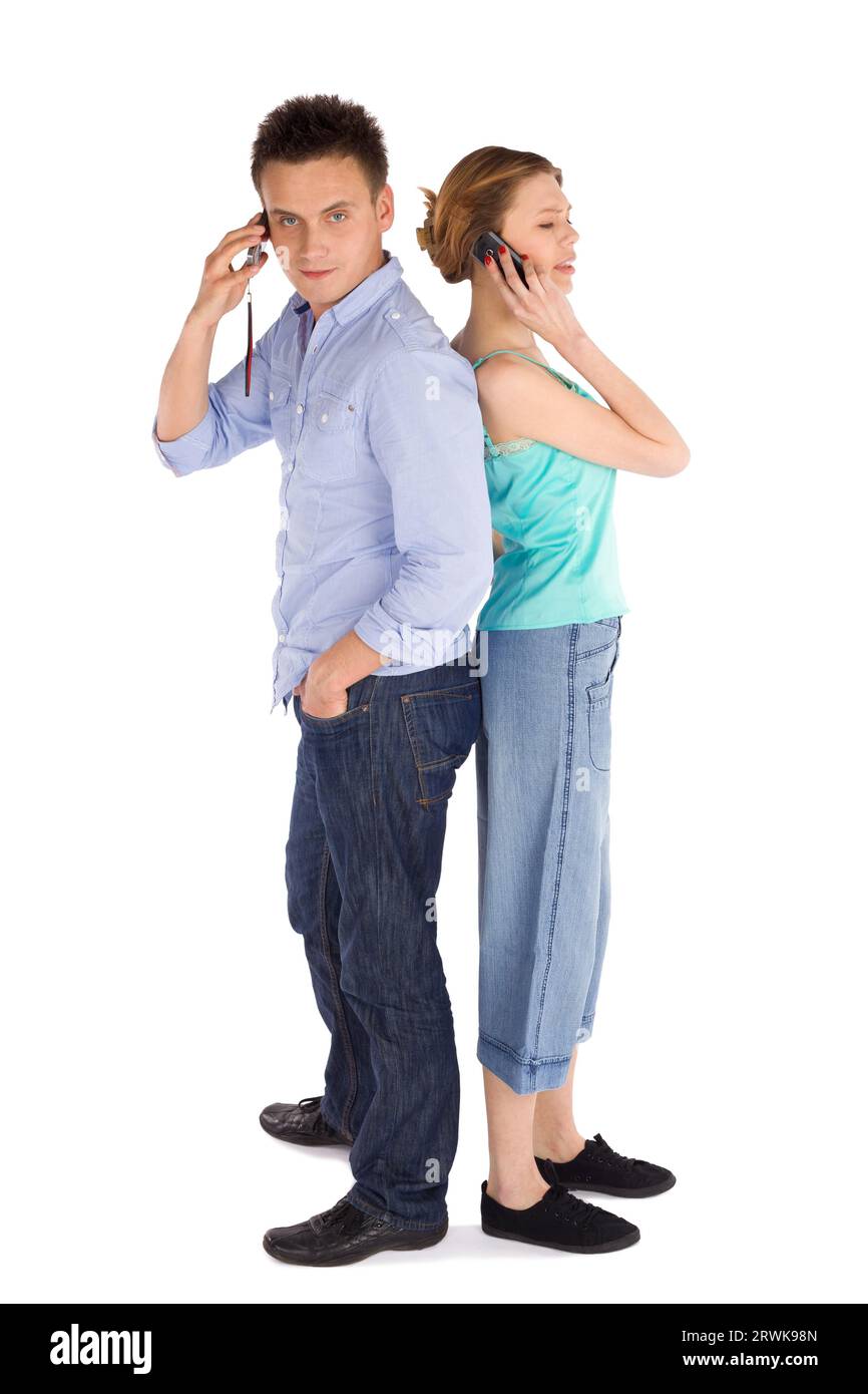 Young attractive casual couple standing back to back, talking on the ...