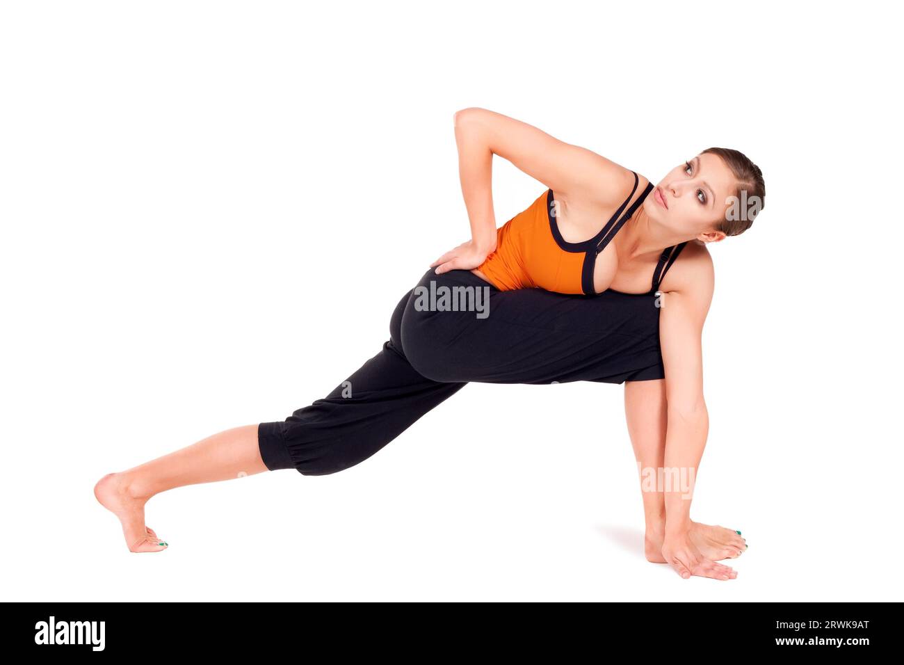 Woman doing second stage of yoga exercise called: Revolved Side Angle ...