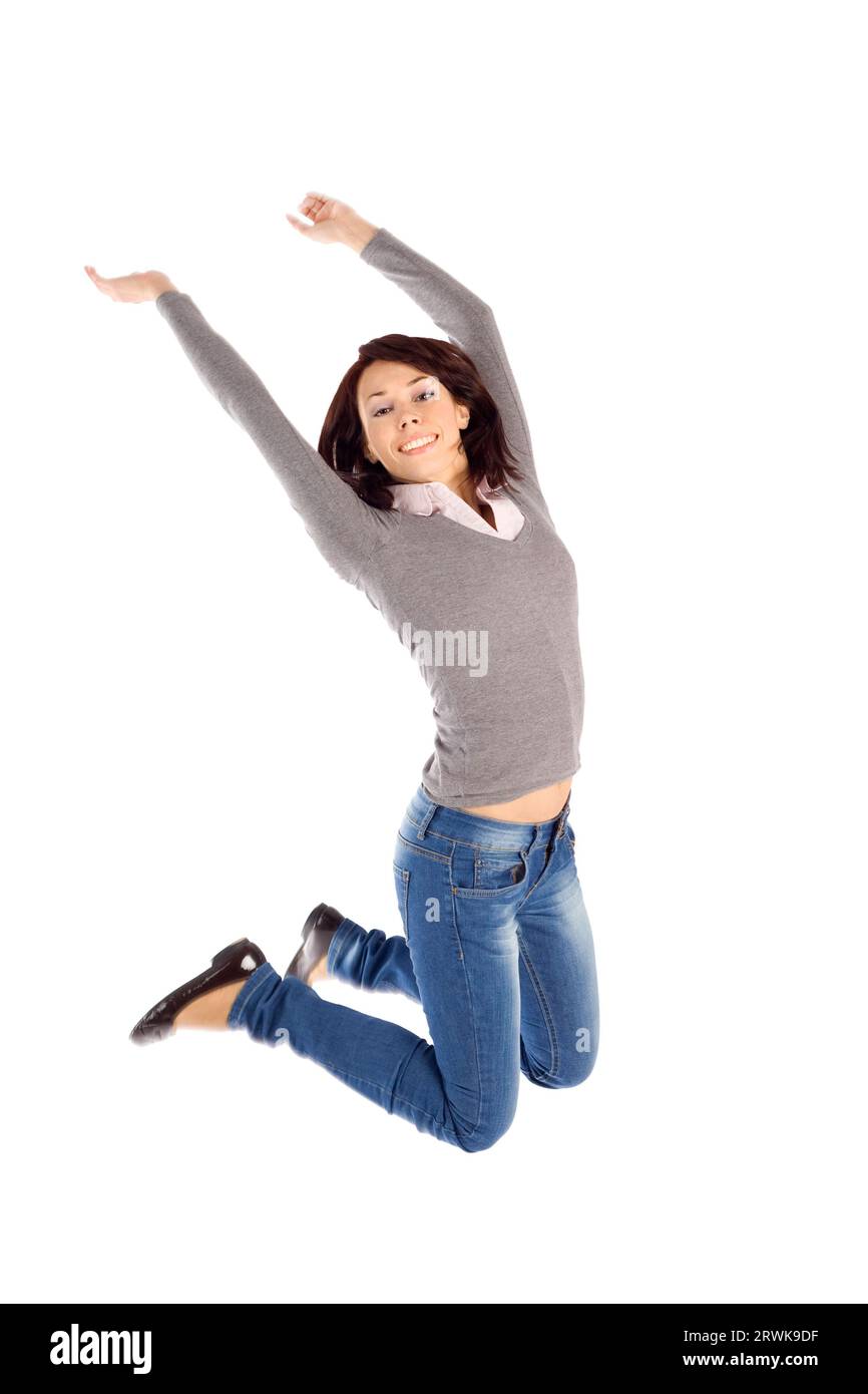 Happy joyful young woman jump into the air isolated on white background ...