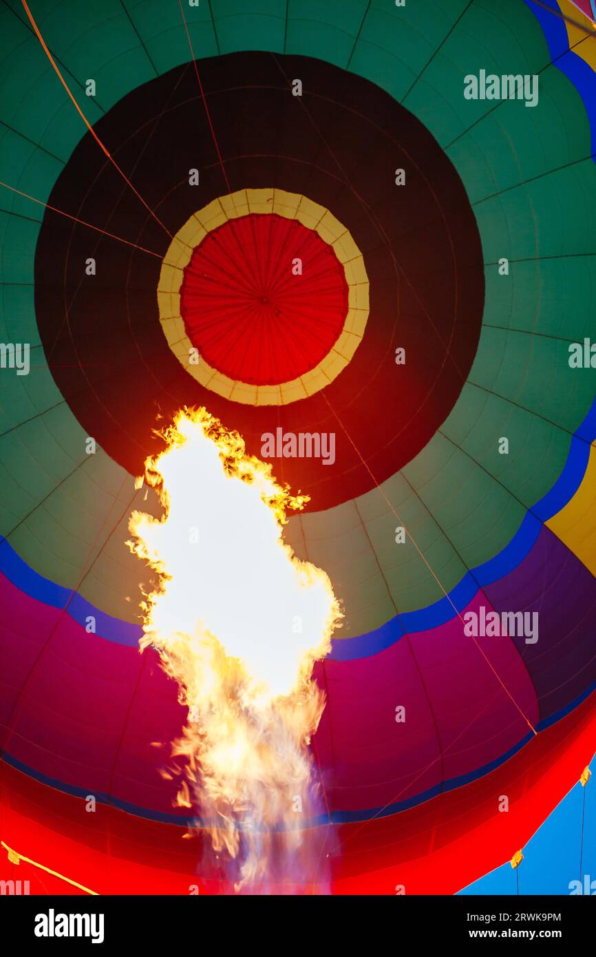 A blast of gas ignites, filling a hot air balloon with warm air on a ...