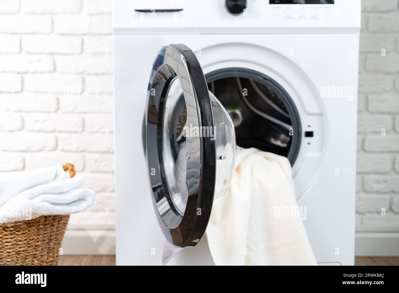 Modern white washing machine in a laundry room Stock Photo - Alamy