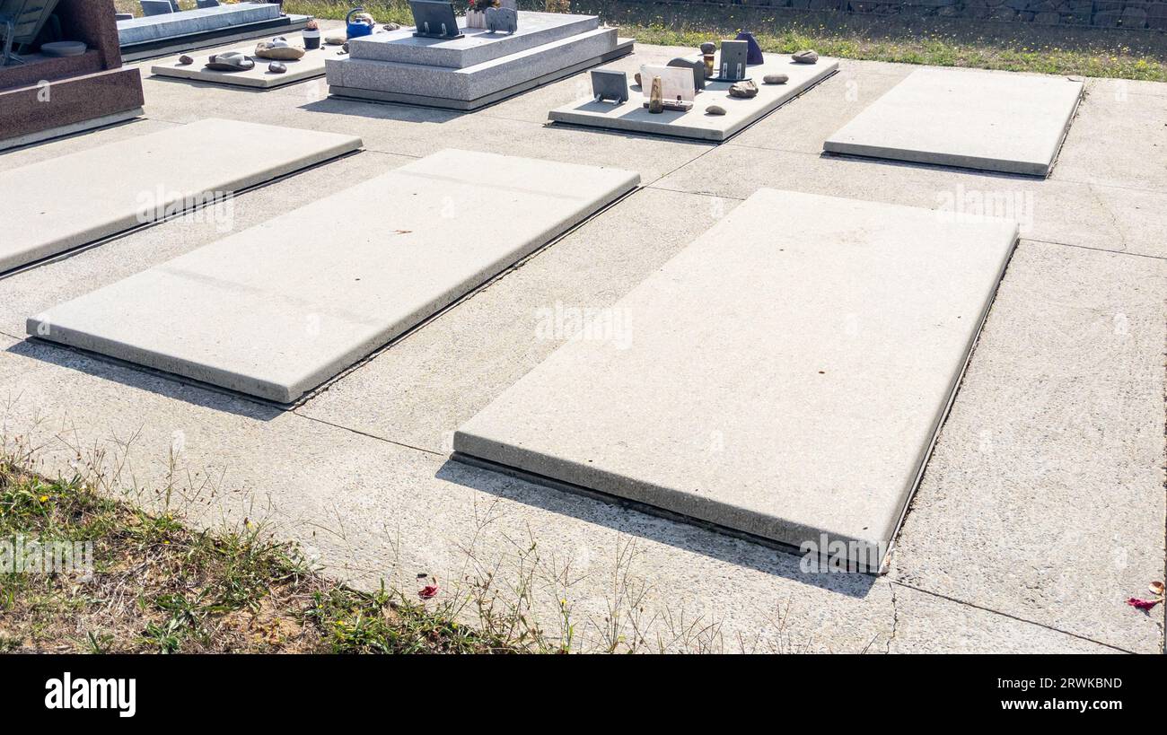 Blank empty gray graves location on cemetery ground ready Stock Photo ...