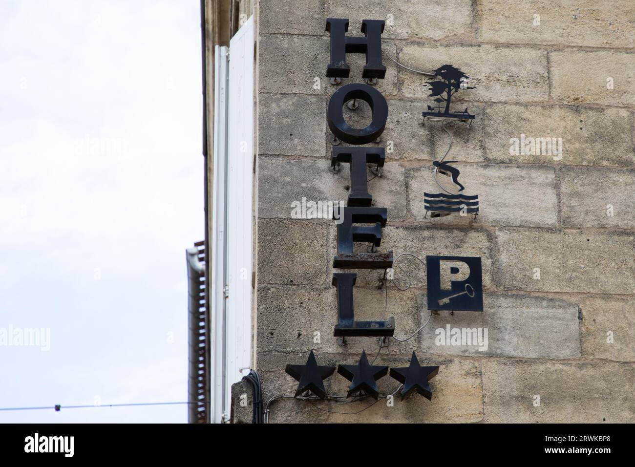 Hotel three stars sign text in wall building facade signage park ...