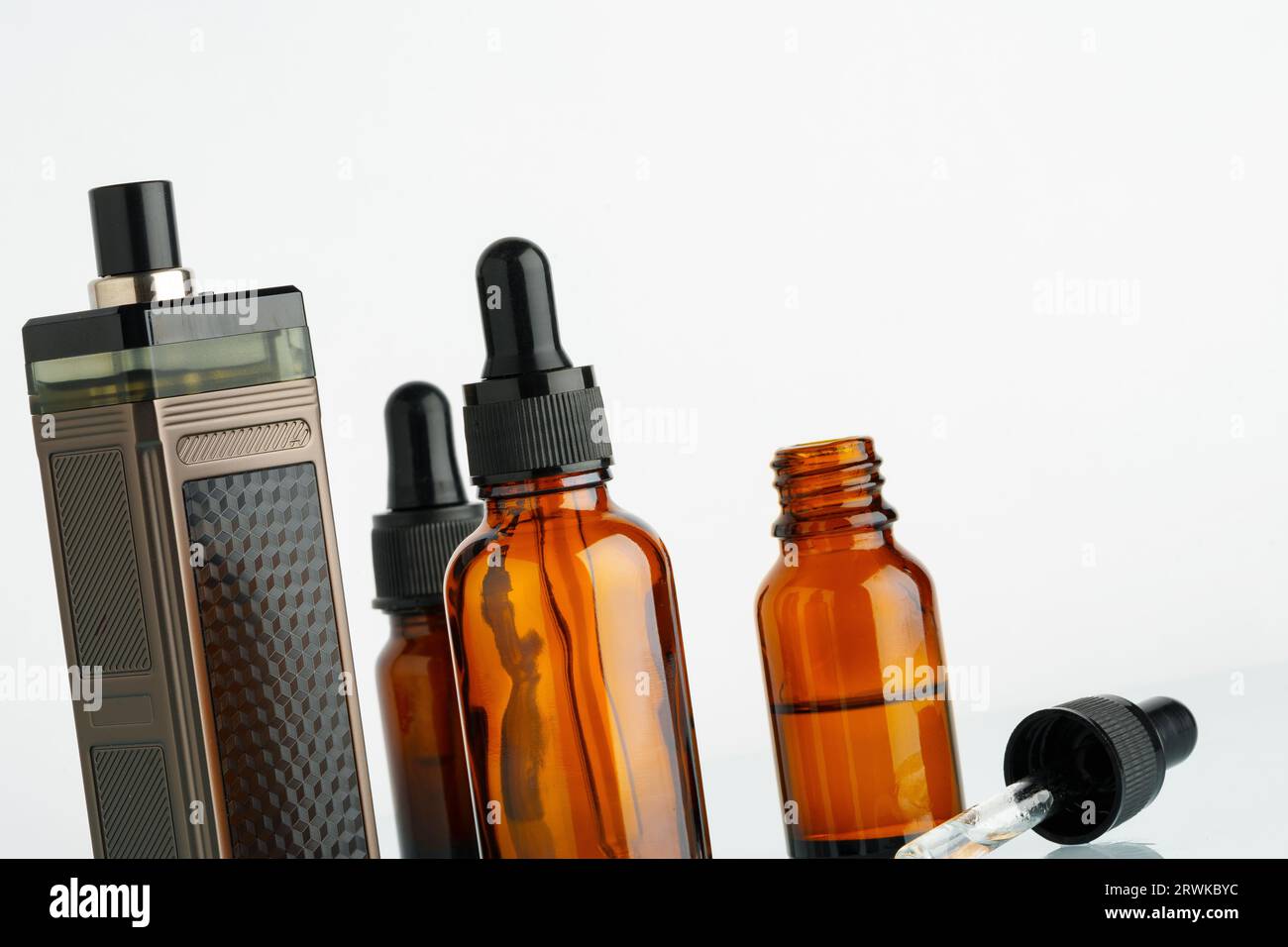 Electronic cigarette with smoking liquid bottle on white background ...