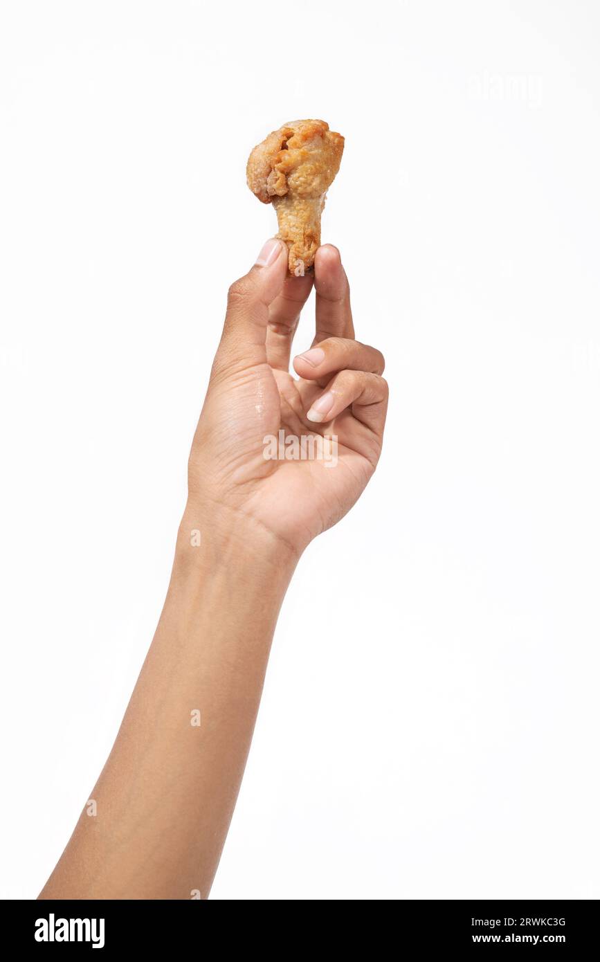 Hand holding grilled chicken wing Cut Out Stock Images & Pictures - Alamy