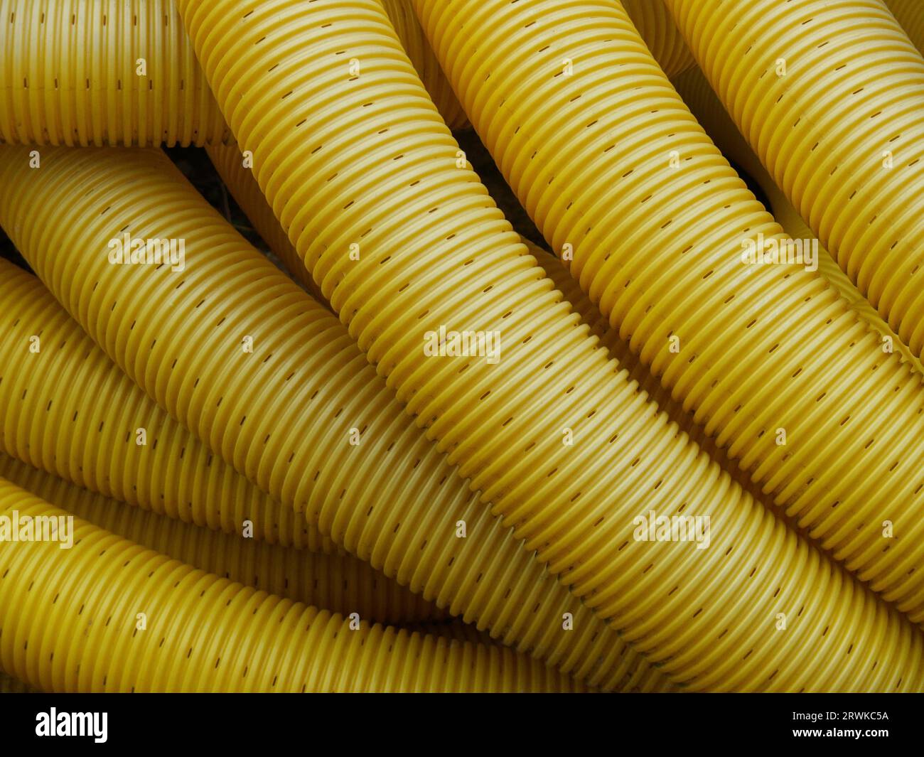 A ball of yellow drainage tubing, used in canal construction Stock ...