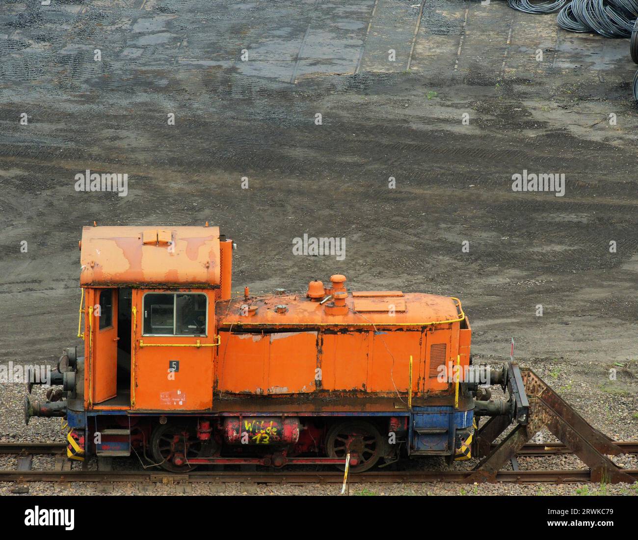 Old orange rail vehicle on a smelter site Stock Photo - Alamy