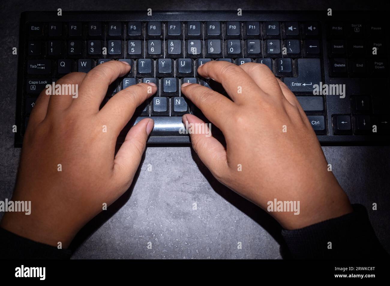 Male hacker typing on keyboard hi-res stock photography and images - Alamy