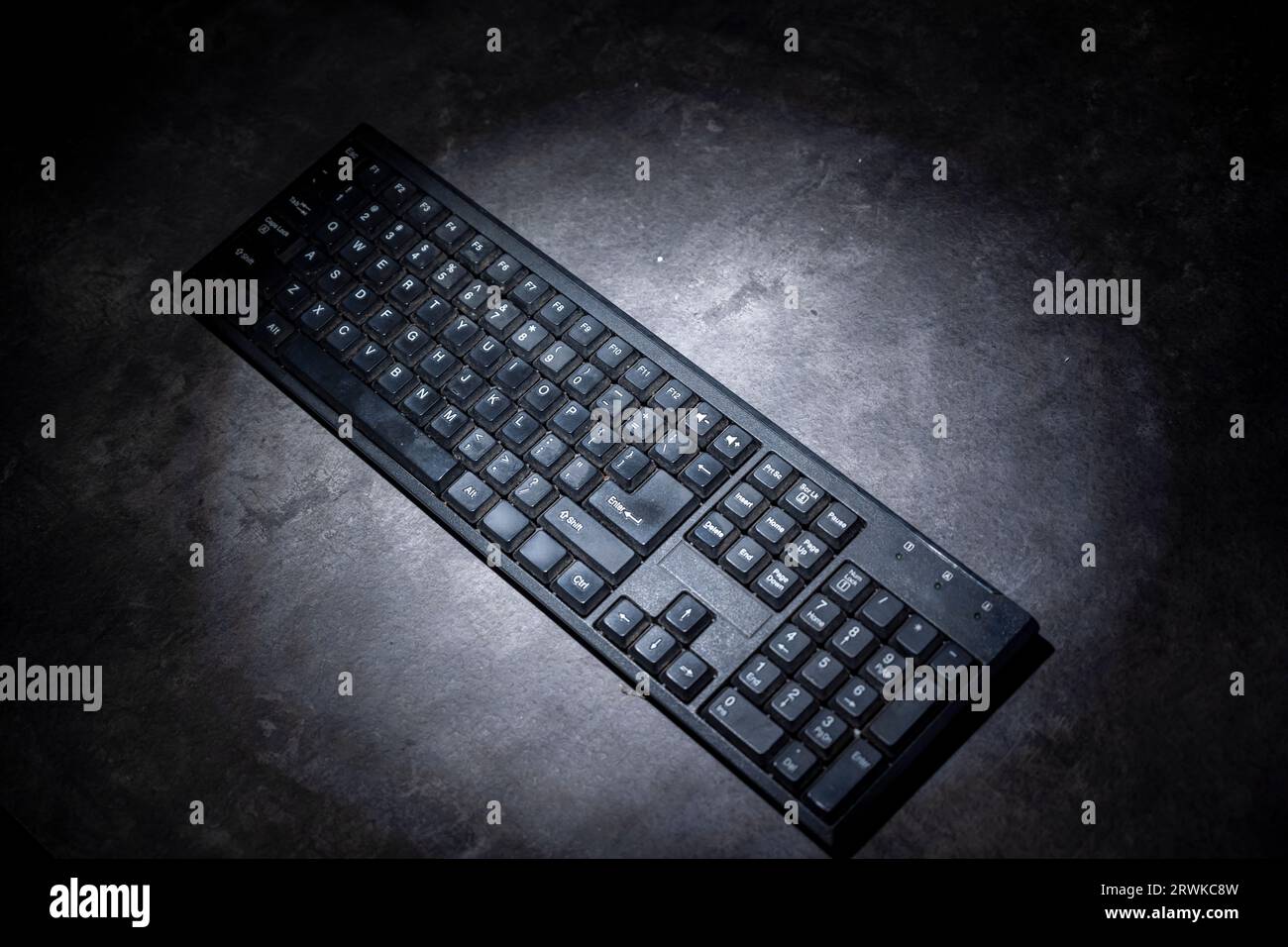 The computer keyboard with a dark background Stock Photo - Alamy
