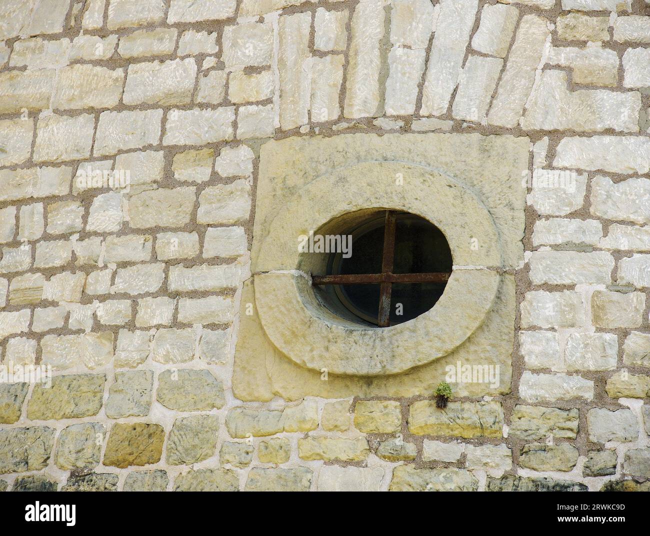 Round castle window with lattice, background, castle facade, detail ...
