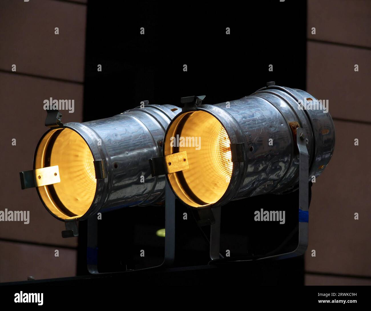 Two studio spotlights, background hall in blur Stock Photo - Alamy