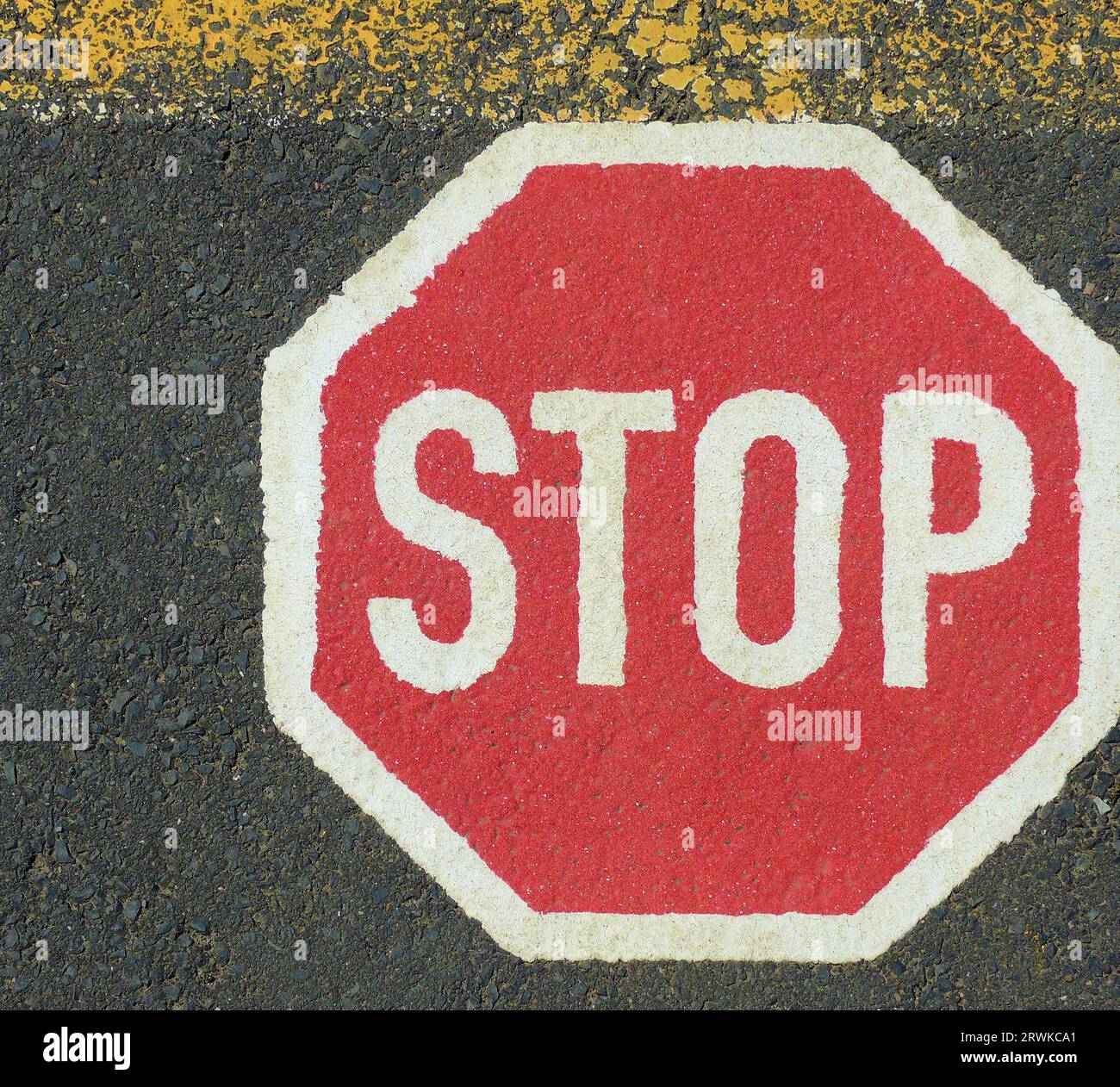 Painted stop symbol on a driving path Stock Photo - Alamy