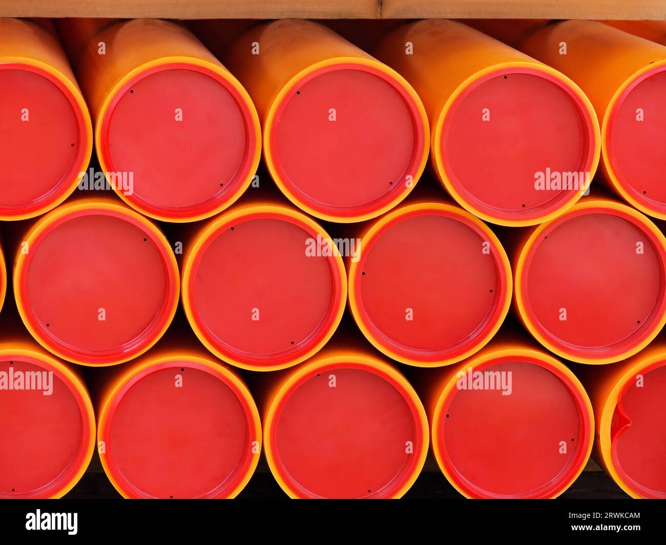 Orange-red plastic pipes, used in canal construction, format-filling ...