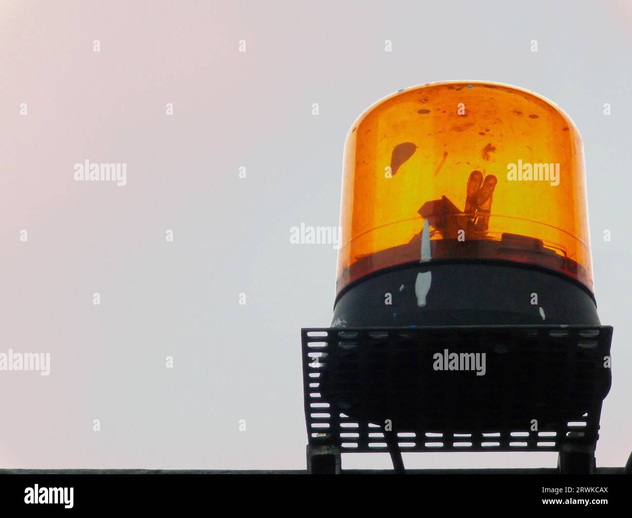 Orange warning lamp, background grey-brown Stock Photo - Alamy
