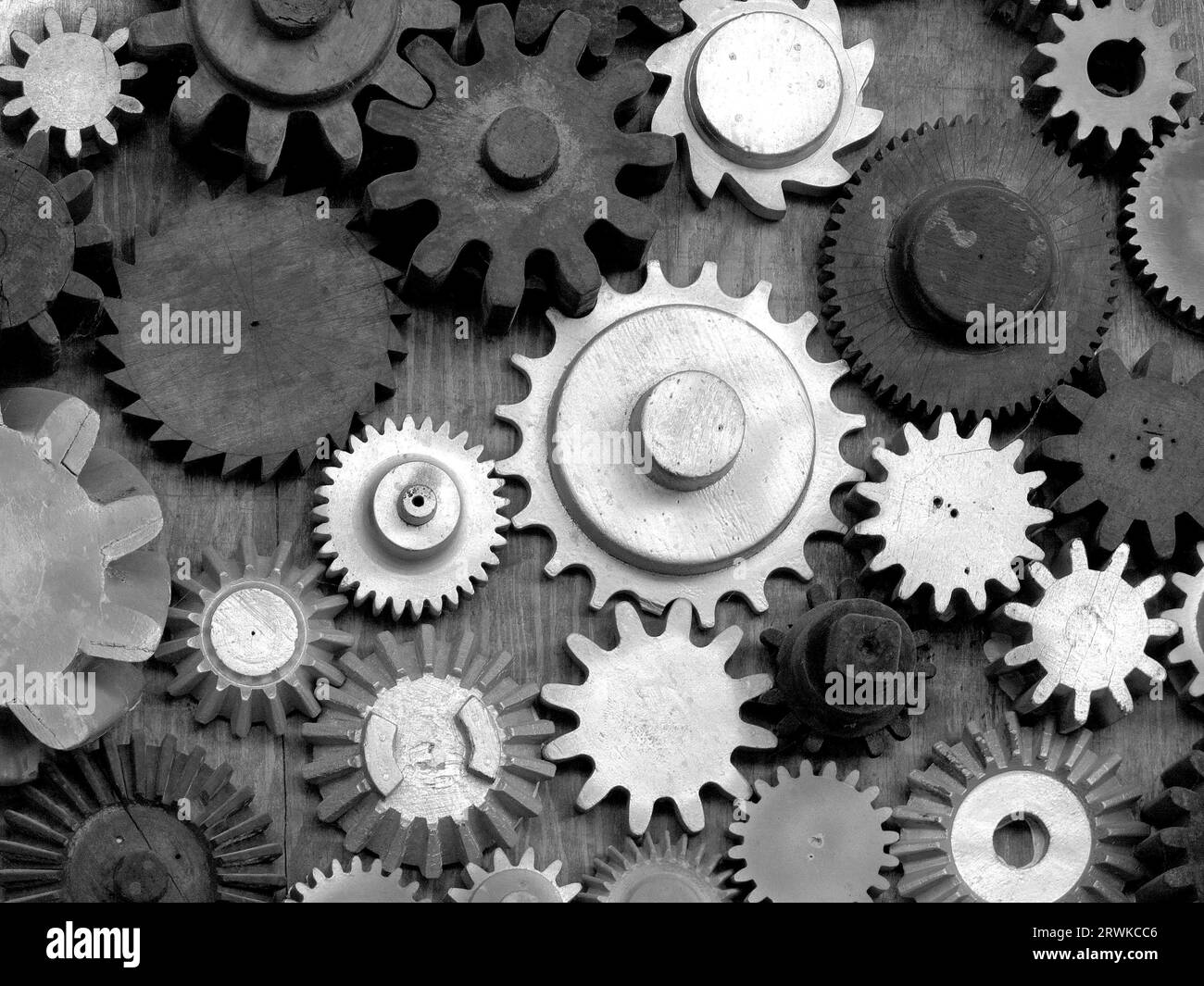 Collage of cogwheels made of metal and wood, detail in s w Stock Photo ...
