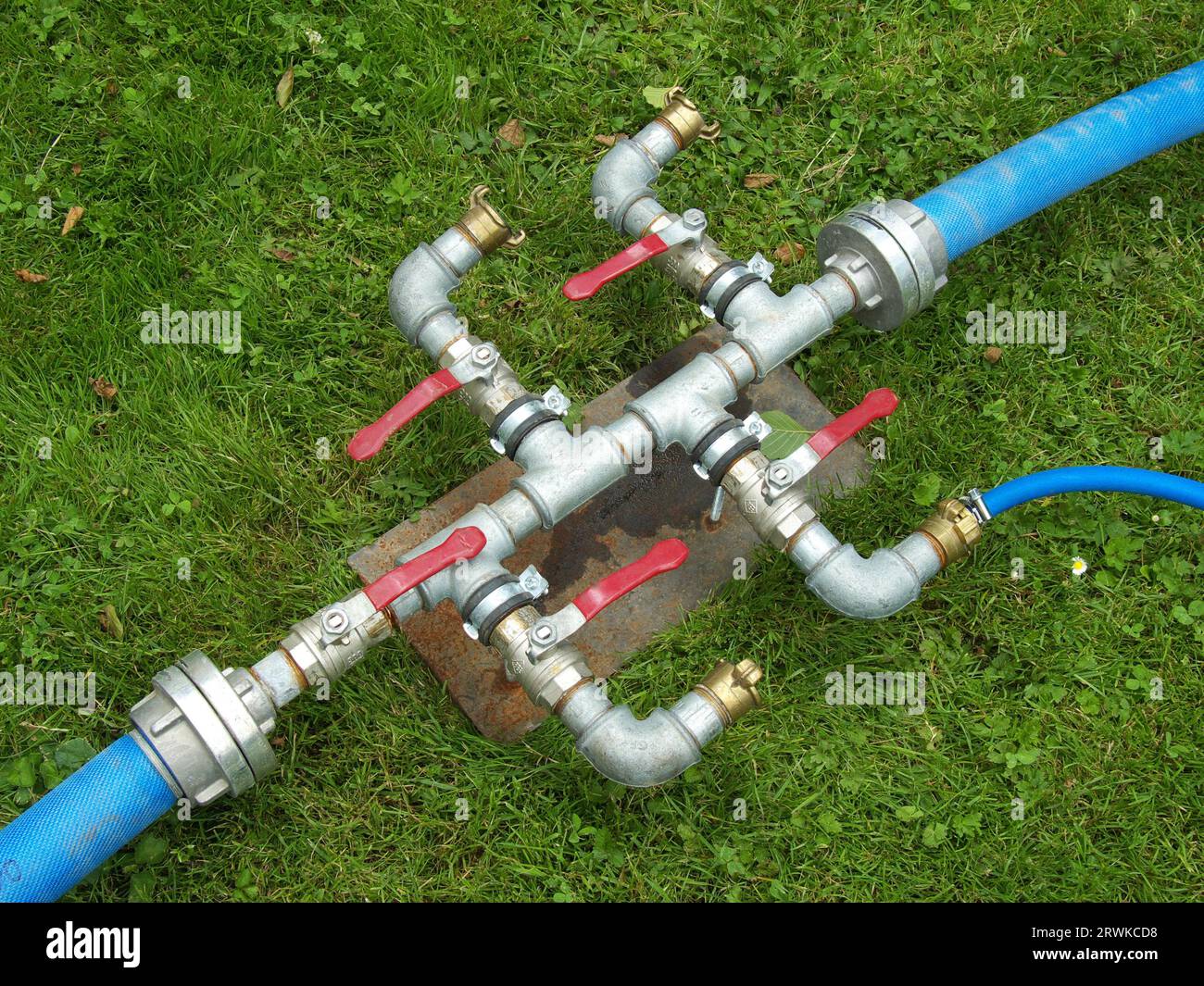 Quadruple water connections, background meadow, detail Stock Photo - Alamy