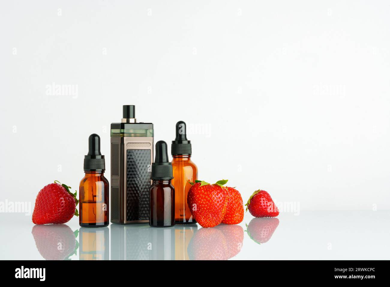 Electronic cigarette liquid with strawberry flavor on white background ...