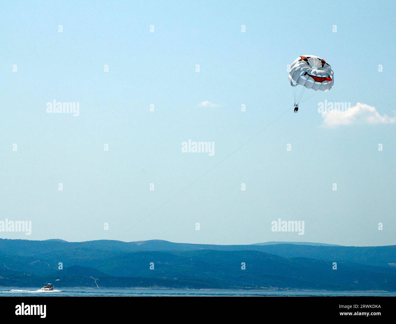 parachuting with speedboat over the crystal clear water of Adriatic sea ...