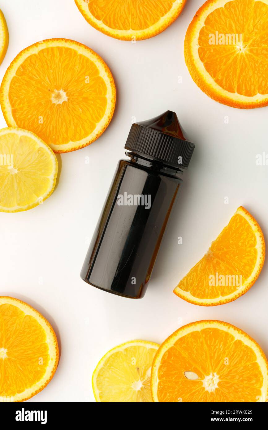 Vape smoking liquid with orange flavor on white background with orange ...