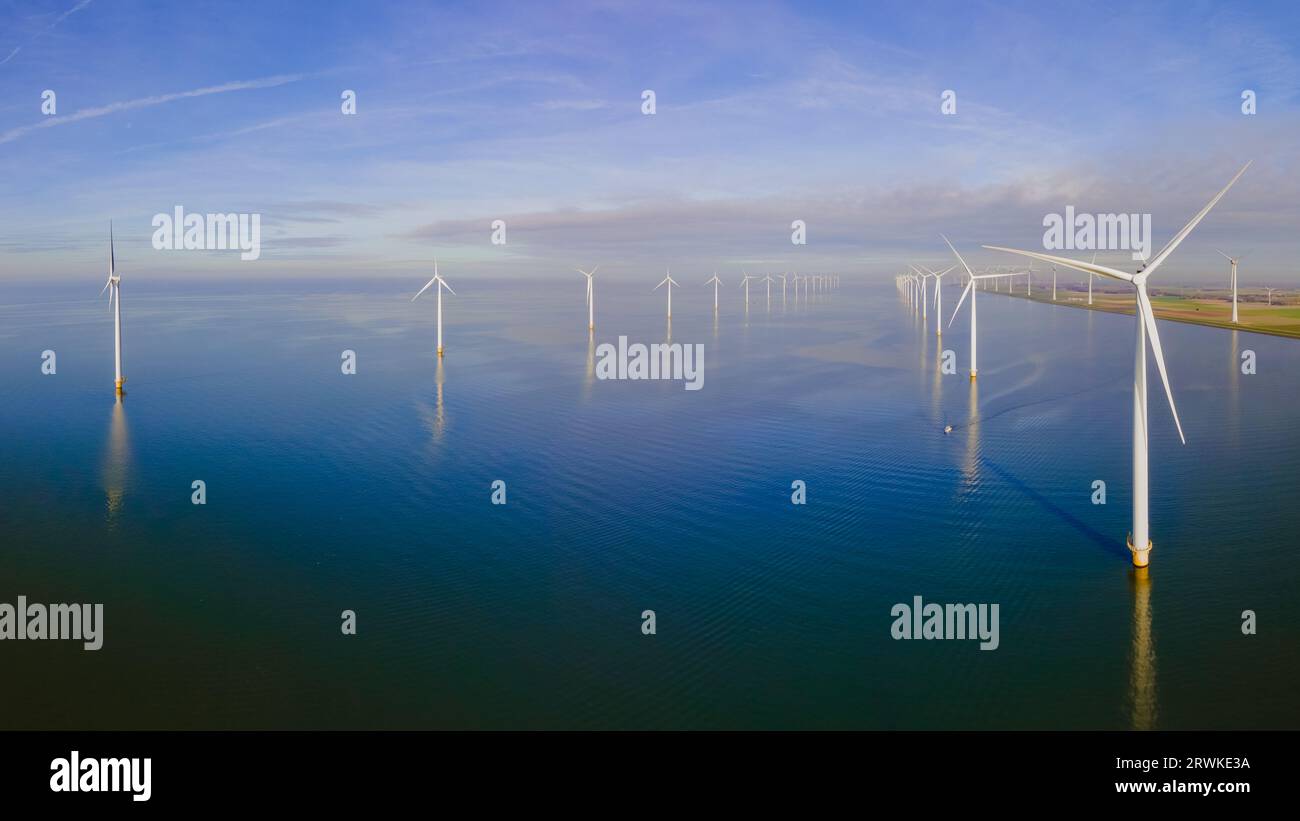 Wind Farm. Windmill farm in the ocean. Offshore wind turbines in the ...