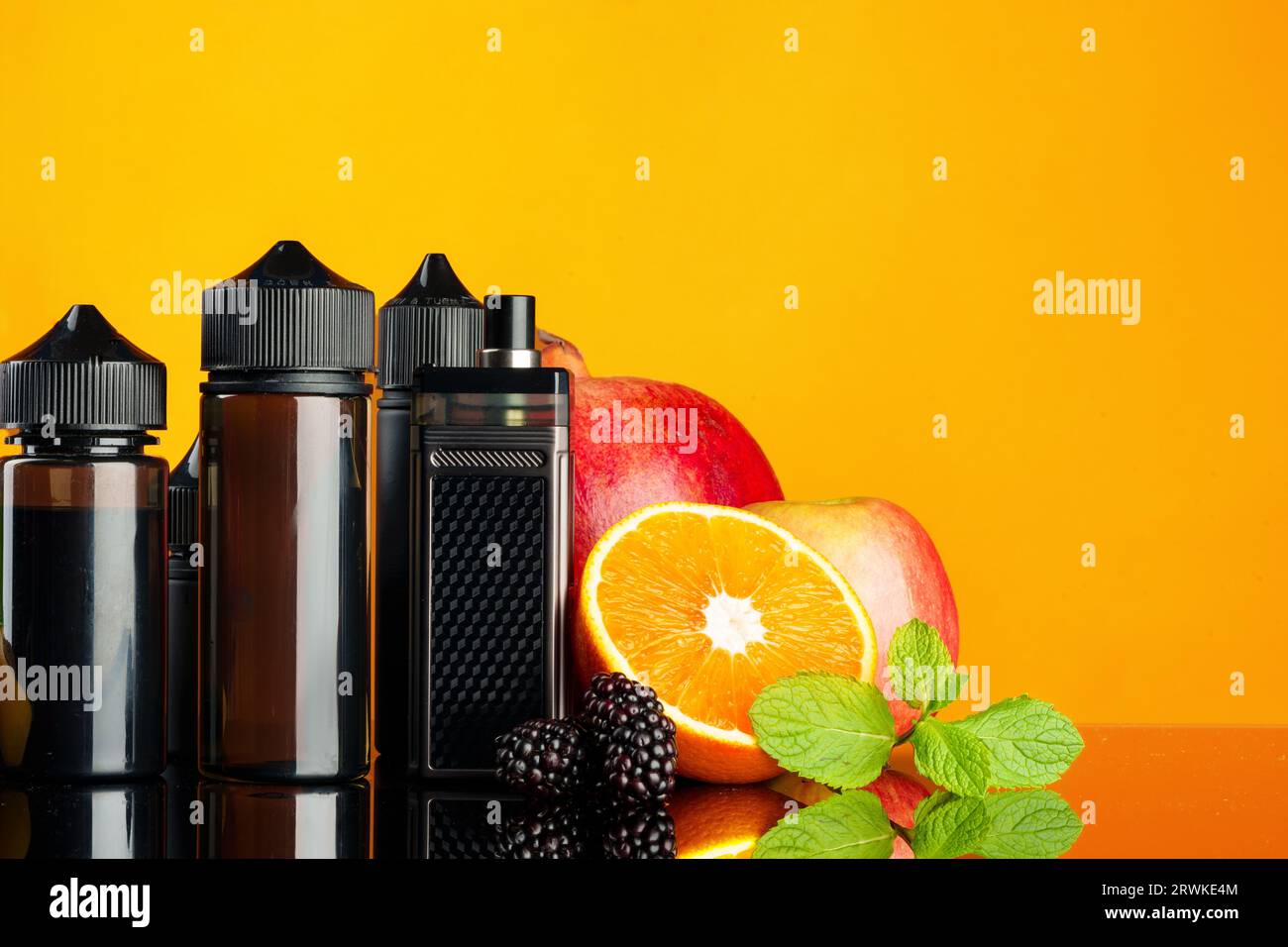 Vape smoking liquid with fruit flavor on orange background Stock Photo ...