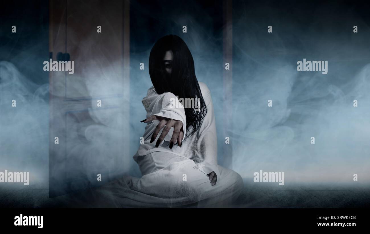 A scary ghost woman crawls on the floor with white smoke background ...