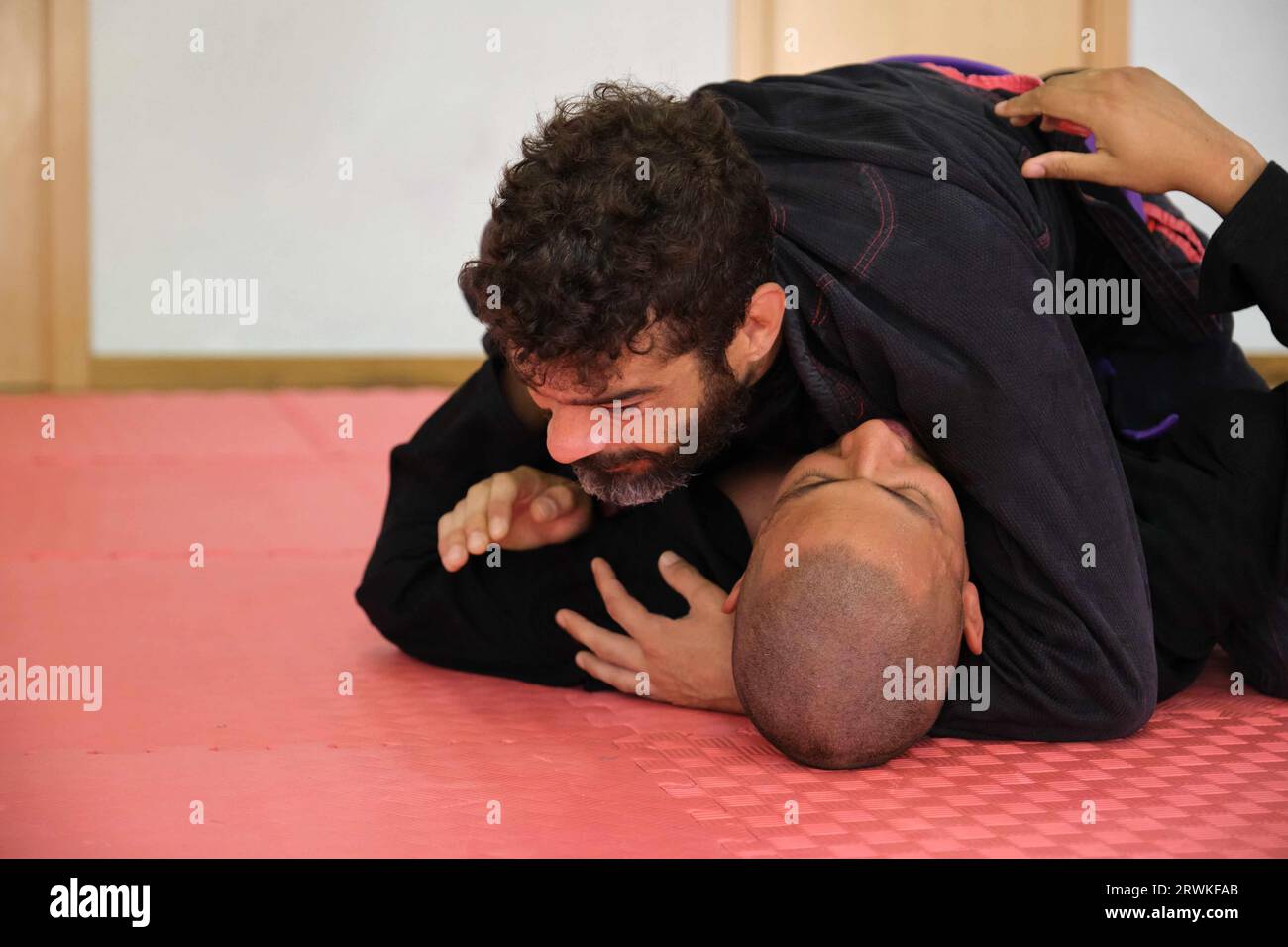 Two men practicing Brazilian Jiu-Jitsu fighting at the School. BJJ ...