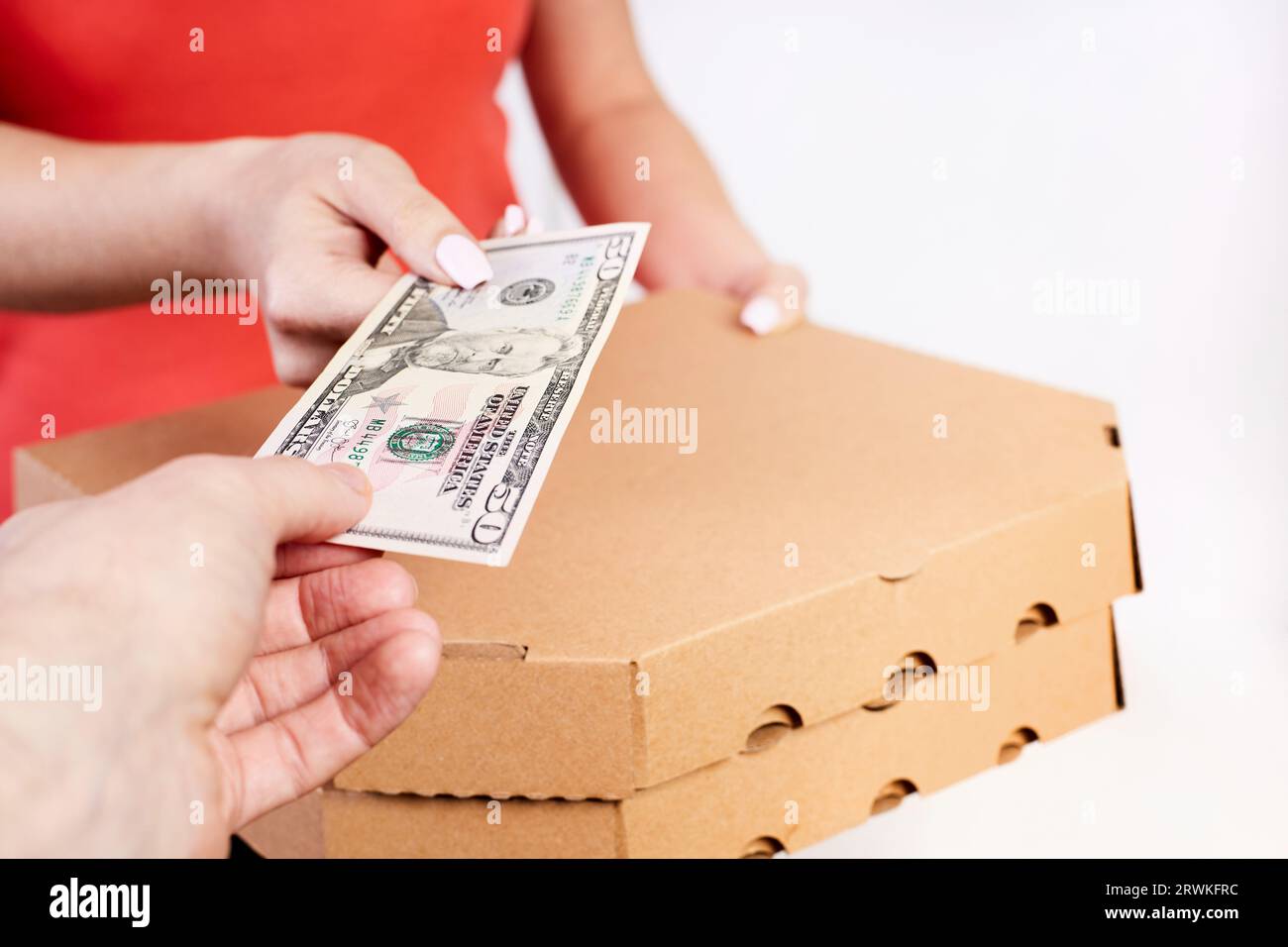 The customer pays the pizza to the delivery man in cash Stock Photo - Alamy