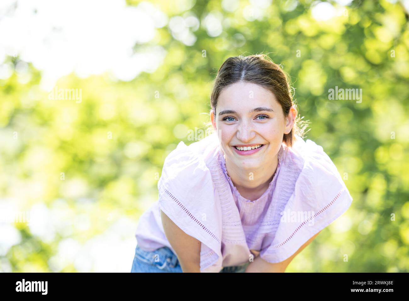 In this enchanting forest portrait, a young and beautiful brunette ...