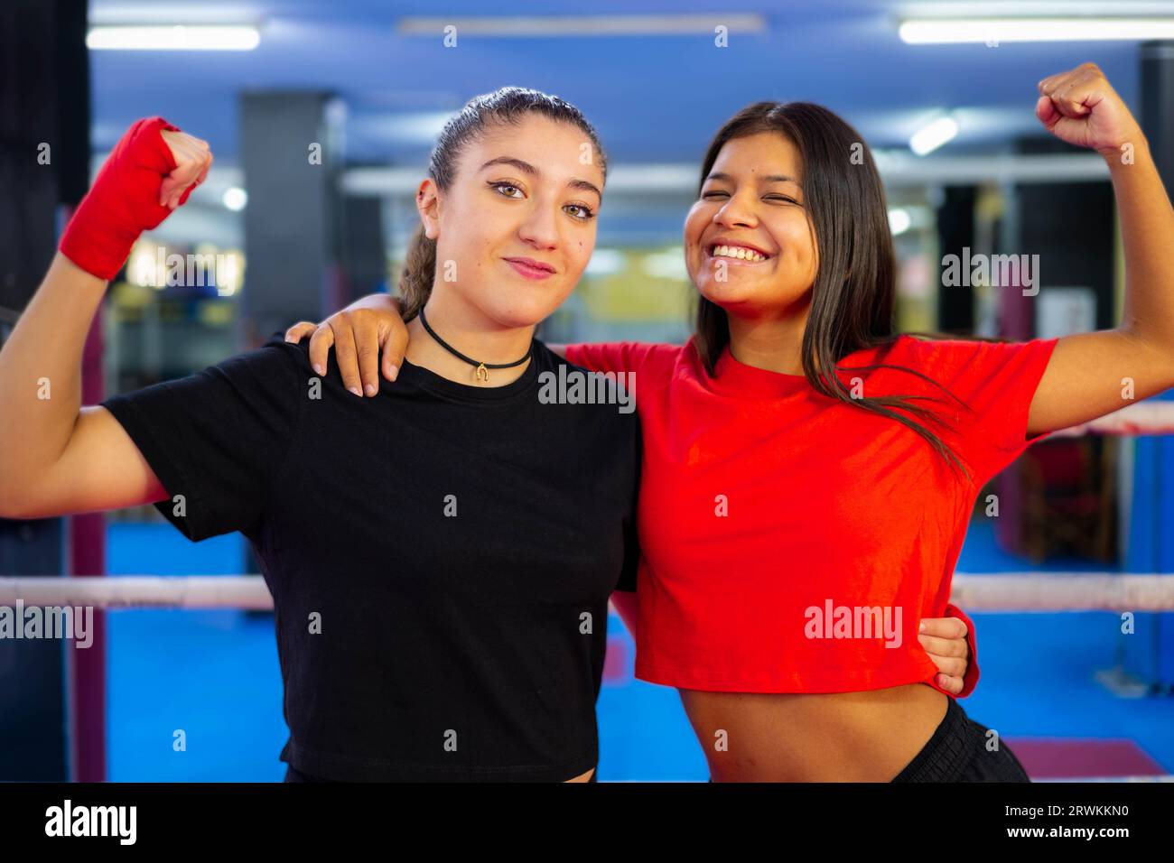 Two multiethnic female boxers portrait in a boxing ring. Fighting sport ...