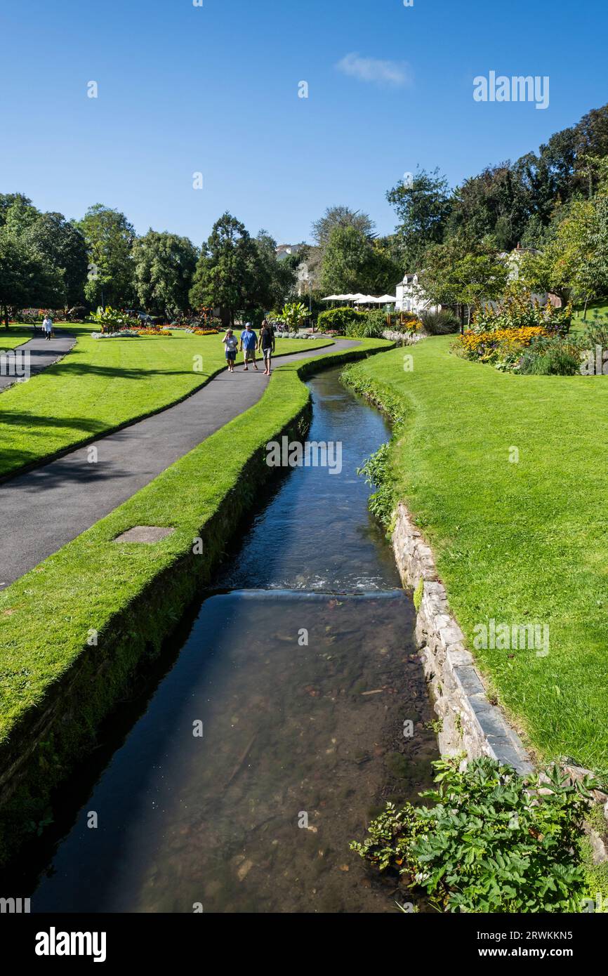 A small river stream flowing through the landscaped Trenance Gardens in ...