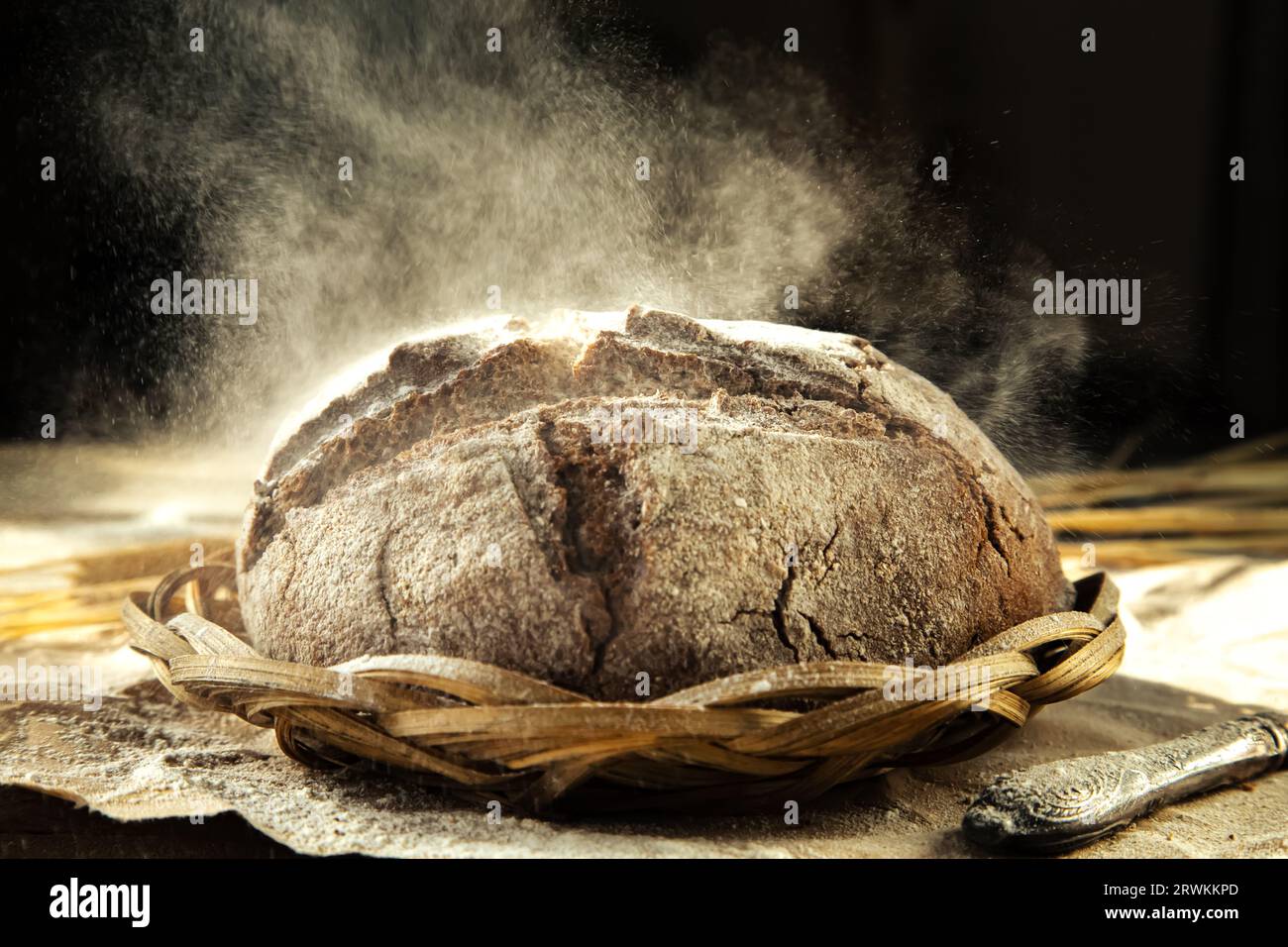 Freshly baked traditional bread in a sprinkle of flour. Yeast-free rye ...