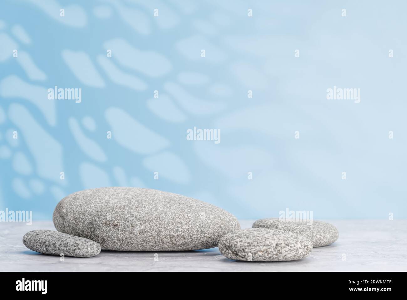 A visually appealing backdrop with smooth sea pebbles and ample copy ...