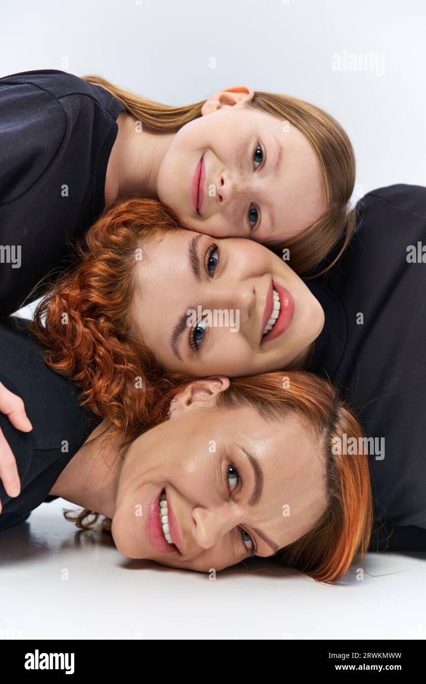 three generations concept, happy women and girl smiling and looking at ...