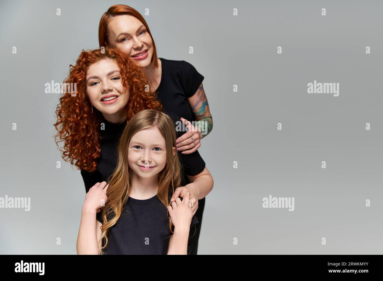 generations concept, delightful family with red hair posing in matching ...