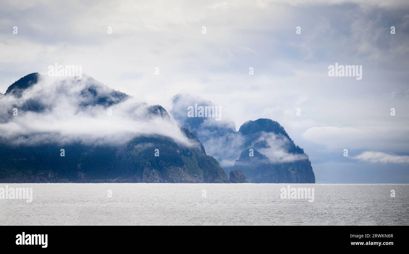 Dramatic mountain cliffs and moody sky at Kenai Fjords National Park ...