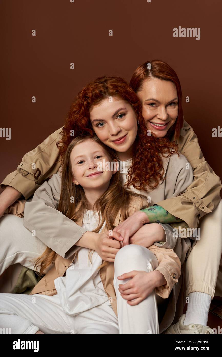 three generations, positive redhead family with freckles looking at ...