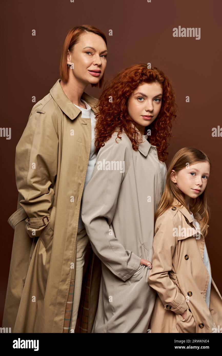 three generations, beautiful redhead women and girl in autumnal coats ...