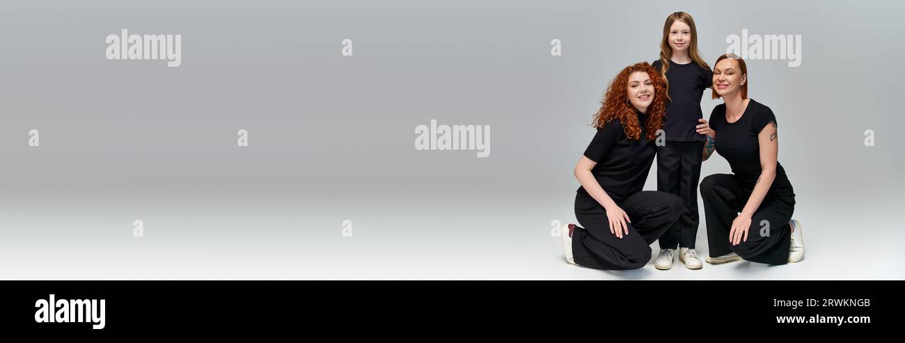 family portrait, three generations of women in matching clothes looking ...