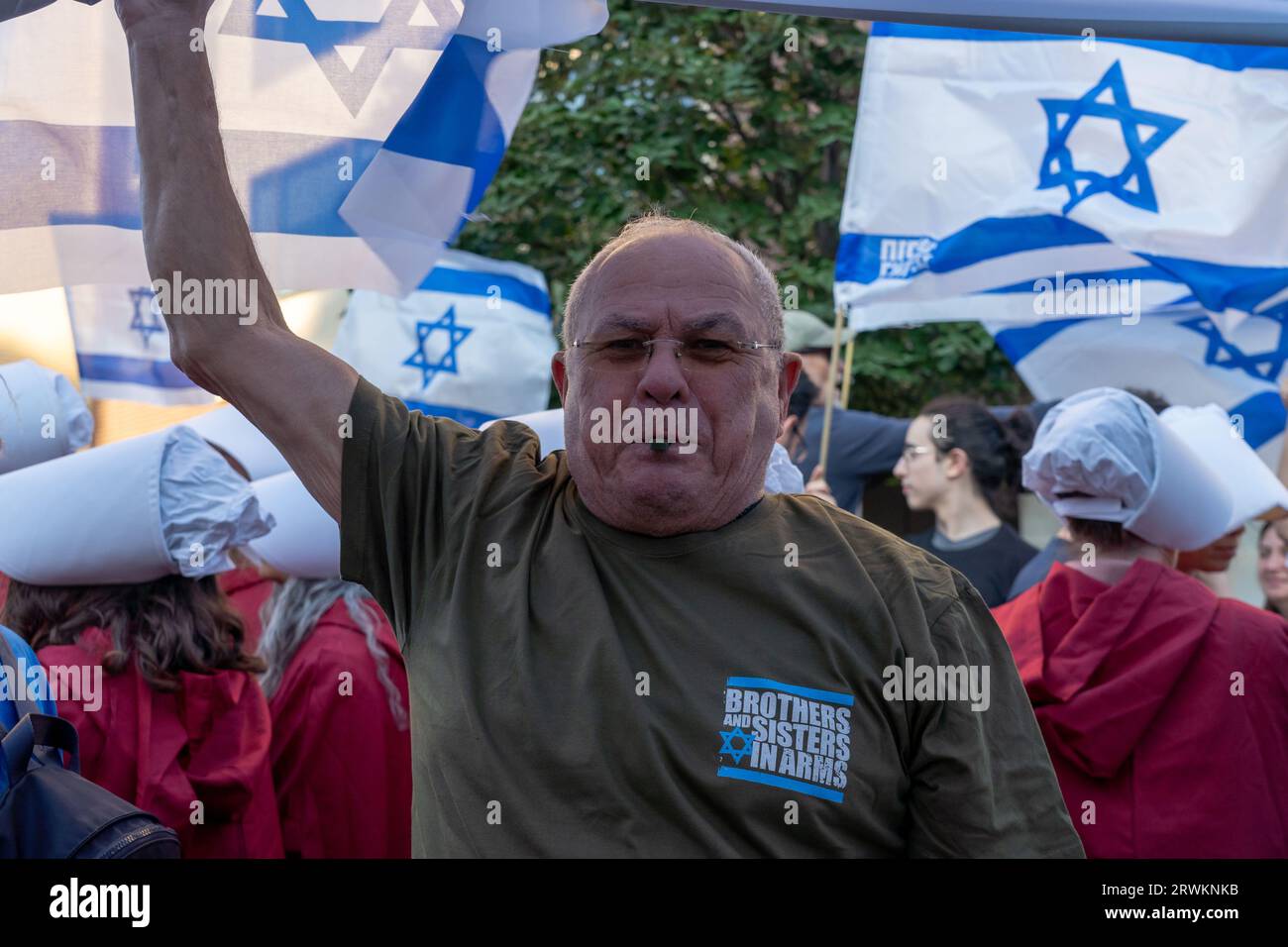 An Israeli Expat wears Brothers and Sisters in Arms shirt and holds an ...