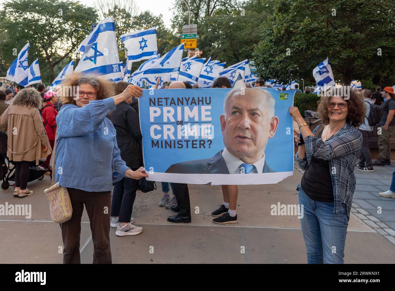 Protesters hold a "Netanyahu Prime Or Crime Minister" banner during a ...