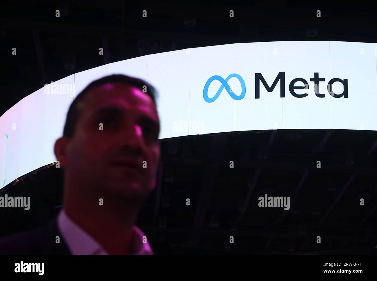 Mumbai, Maharashtra, India. 20th Sep, 2023. A man walks past a logo of ...