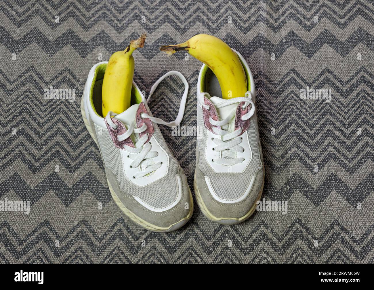 ripe bananas inside a pair of sneakers shoes Stock Photo - Alamy
