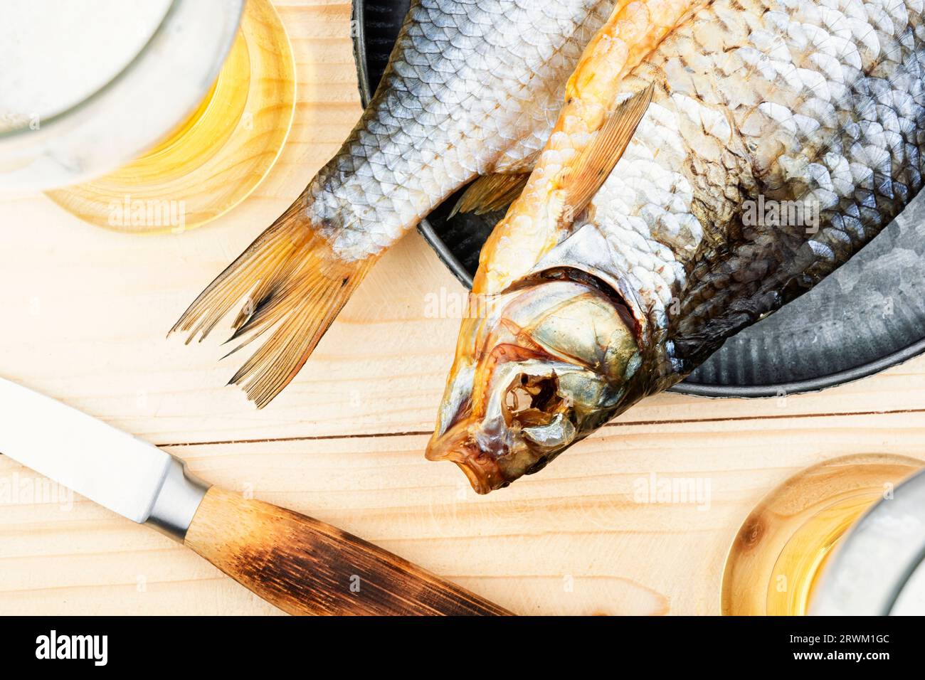 Two dried salted fish on the wooden table.Stockfish Stock Photo - Alamy
