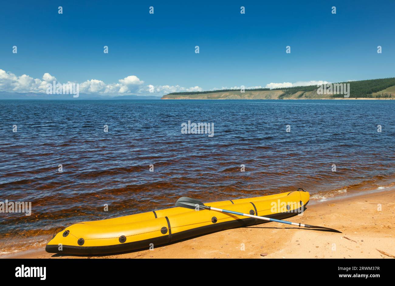Yellow packraft, portable inflatable rubber boat with padle on Khovsgol ...